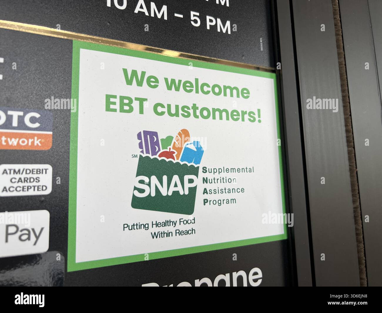 Sign at supermarket entrance with text reading We Welcome EBT customers ...