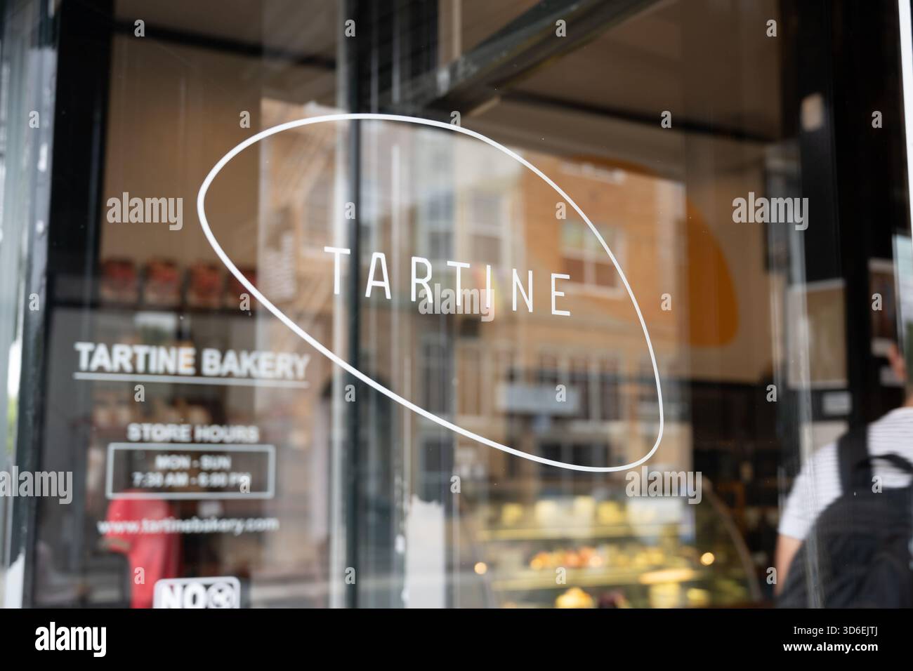 Close-up of Tartine Bakery logo and storefront window with reflections ...