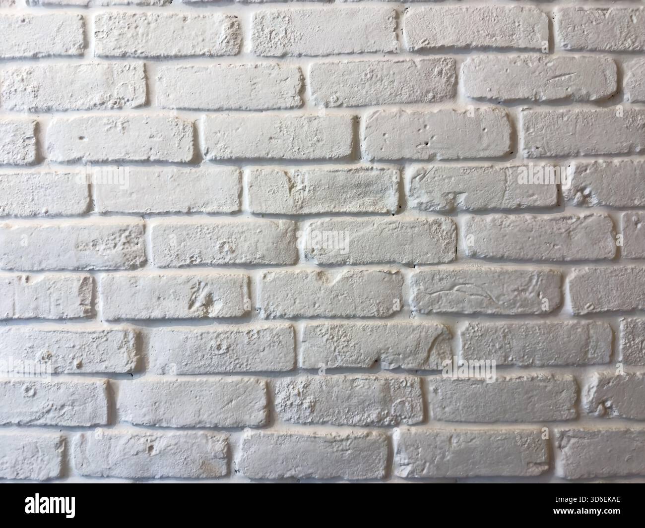 Textured white brick wall under soft daylight, showing rough plaster ...