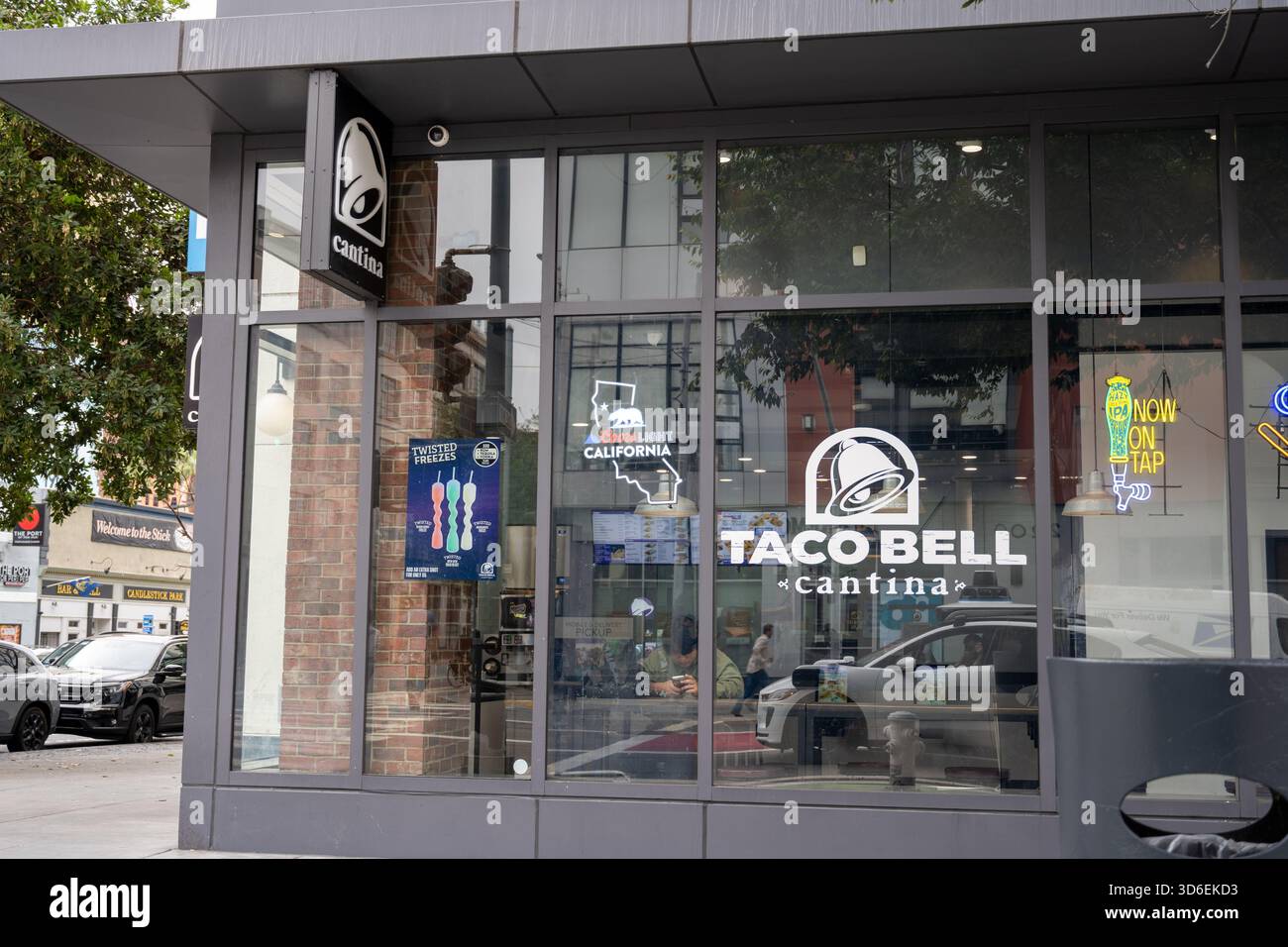 Facade of Taco Bell Cantina restaurant with logo and neon signs in ...