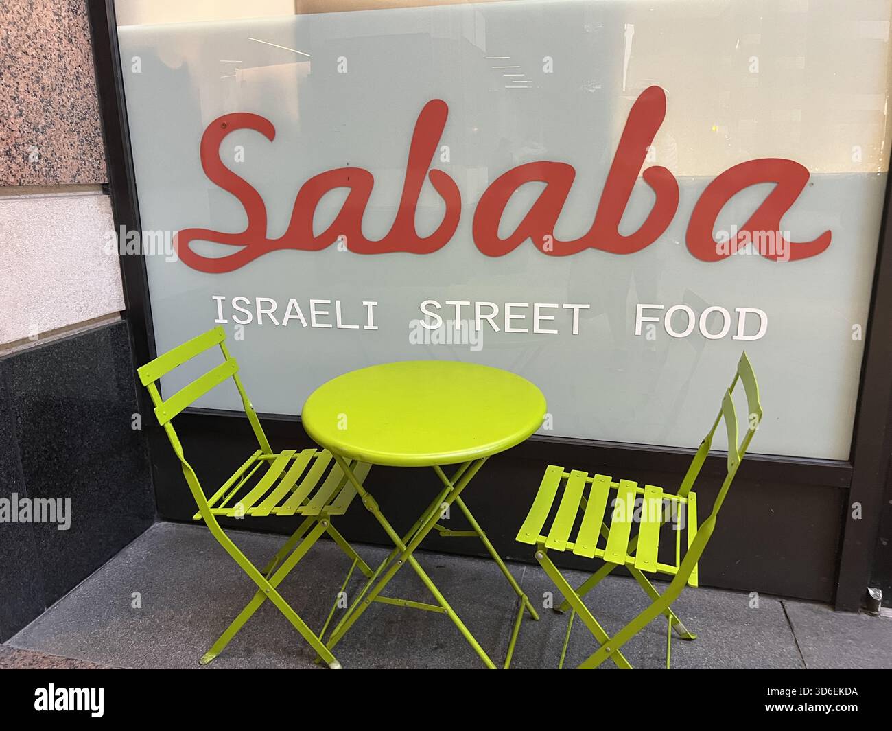 Table, chairs and sign for Sababa Israeli Street Food restaurant in San ...