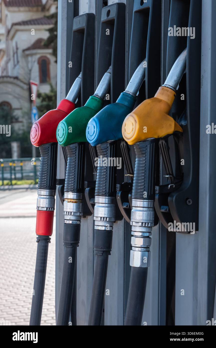 Close-up of fuel pump nozzles at gas station. Colorful fuel pump ...