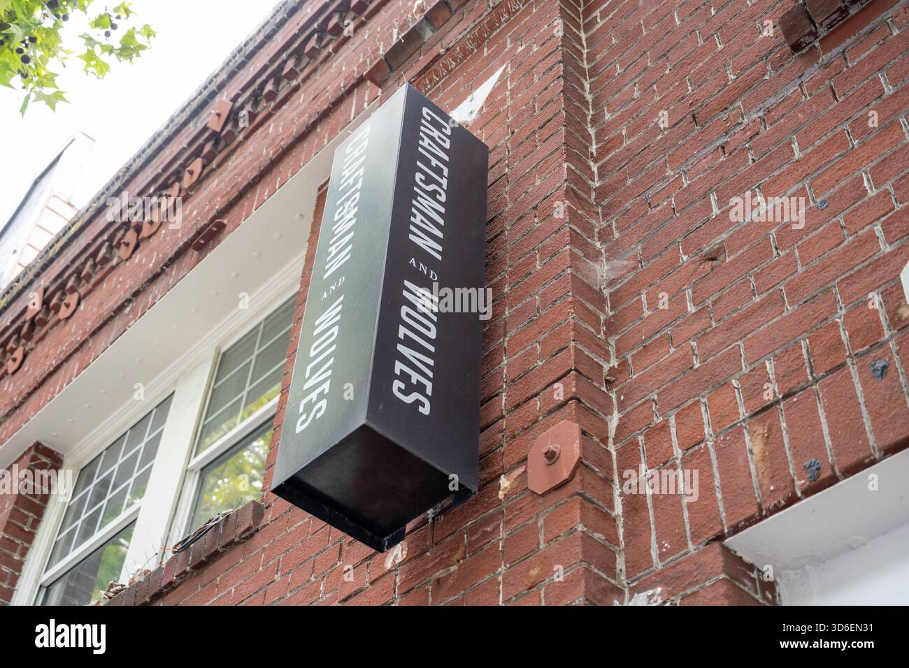 Vertical blade sign for Craftsman and Wolves on a red brick storefront ...