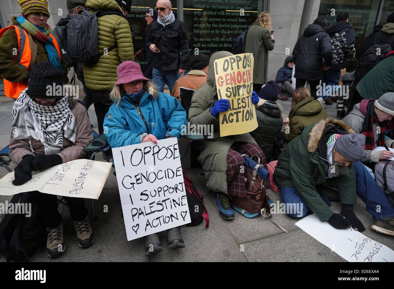 Protesters hold placards outside the Ministry of Justice during a ...