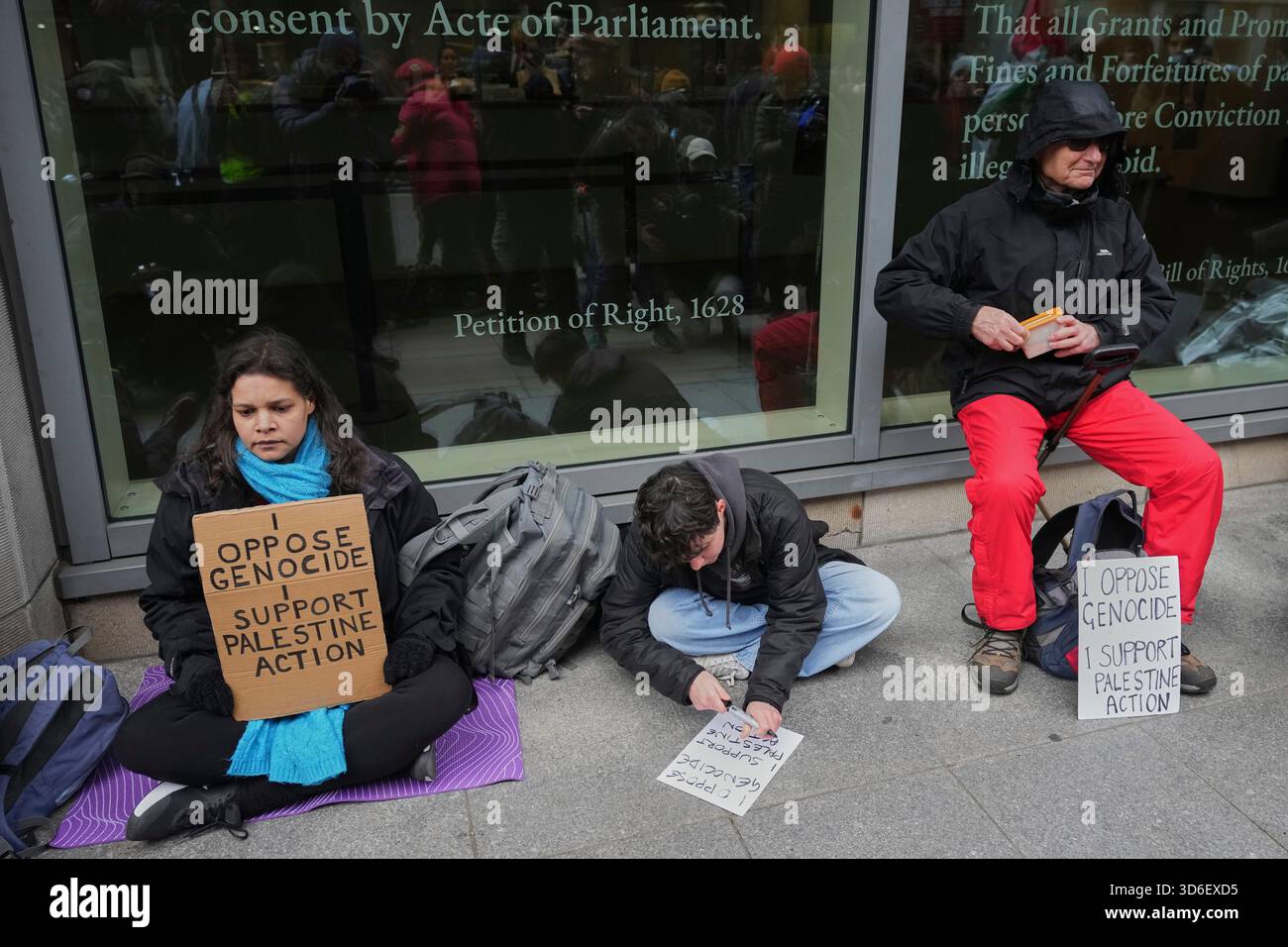 Protesters hold placards outside the Ministry of Justice during a ...