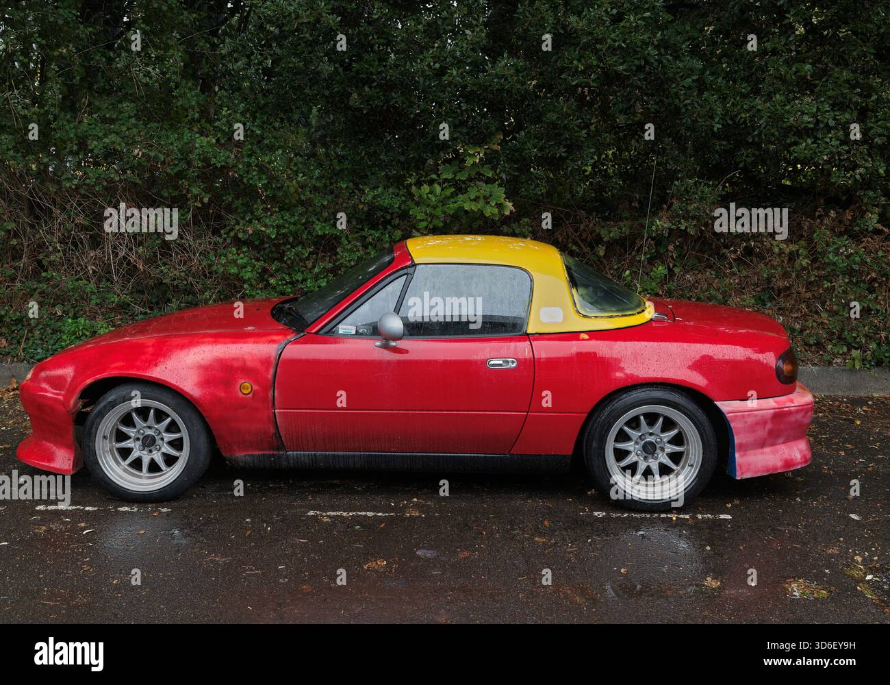A red and yellow sports car parked on a road in Christchurch, England ...