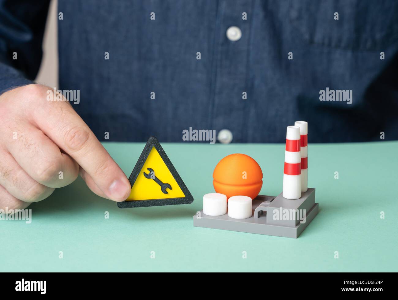A man shuts down an industrial plant for scheduled maintenance. Routine ...