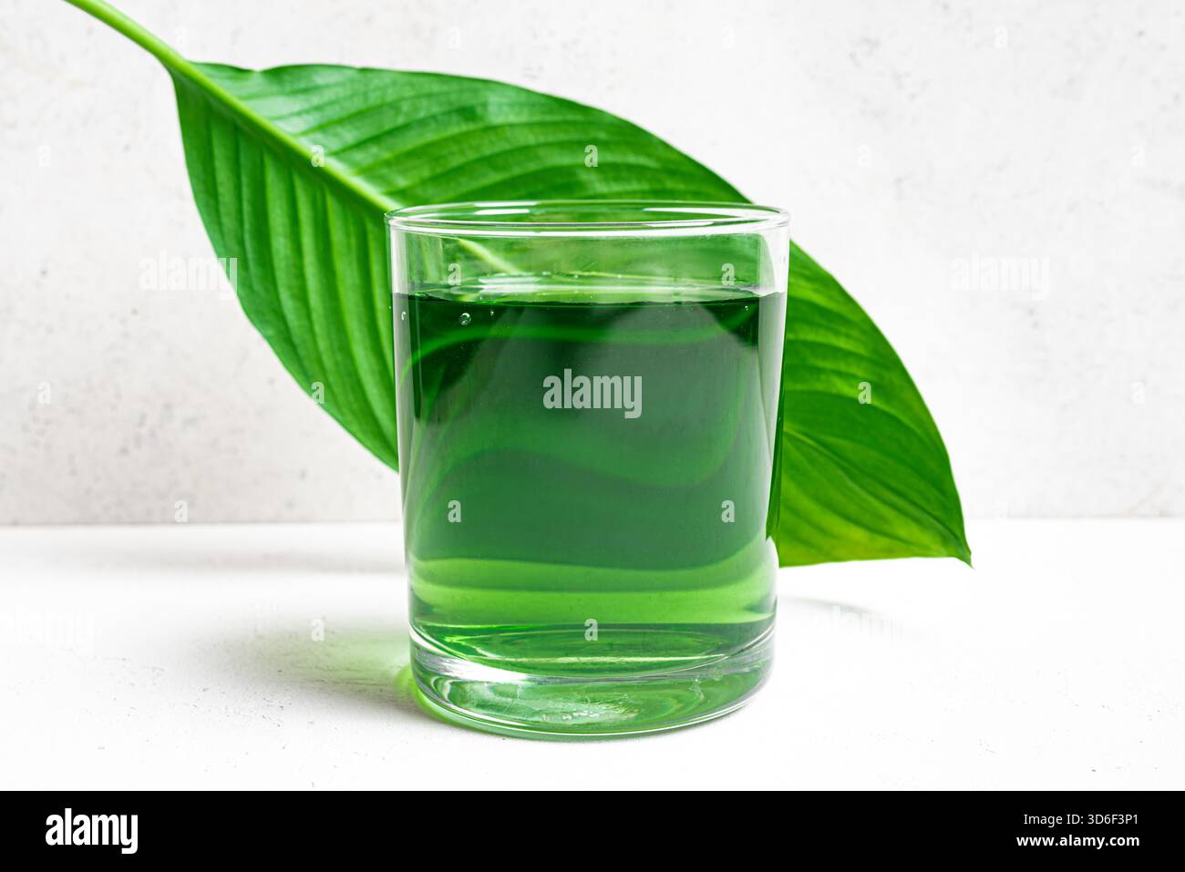 Liquid Green Chlorophyll Drink. Glass of Chrorophyll Water on white ...