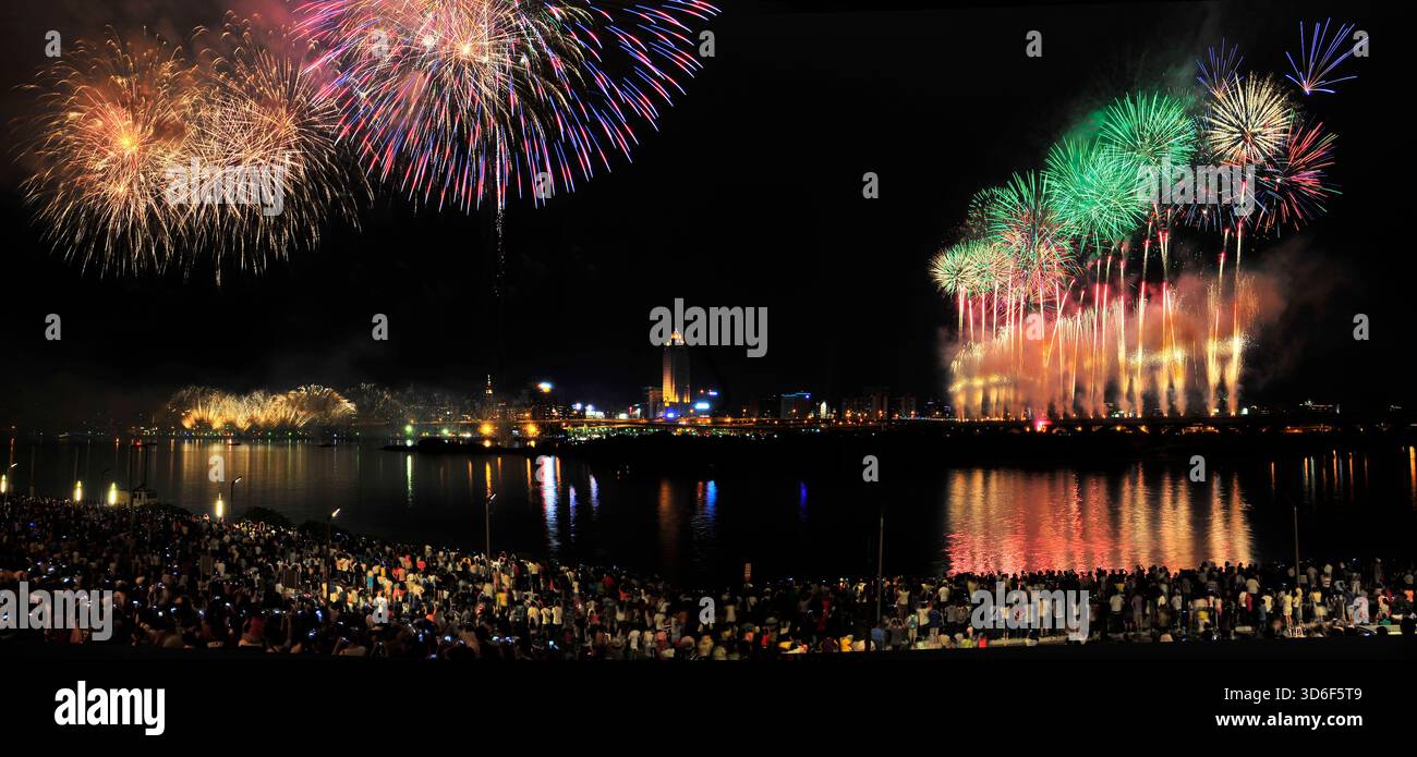 New Year fireworks over Rainbow Bridge and Taipei skyline reflection ...