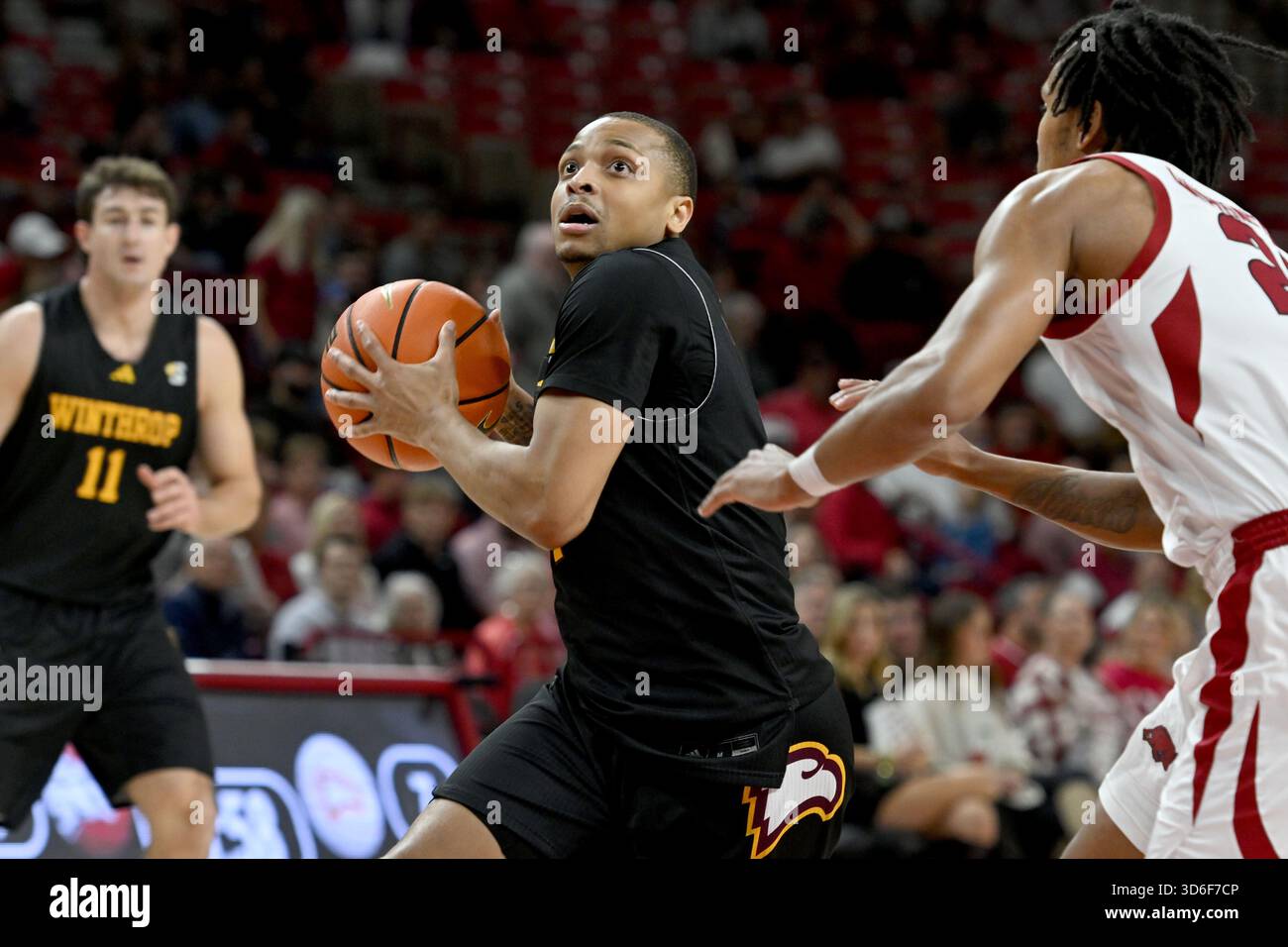 Winthrop guard Isaiah Wilson (1) drives past an Arkansas defender ...