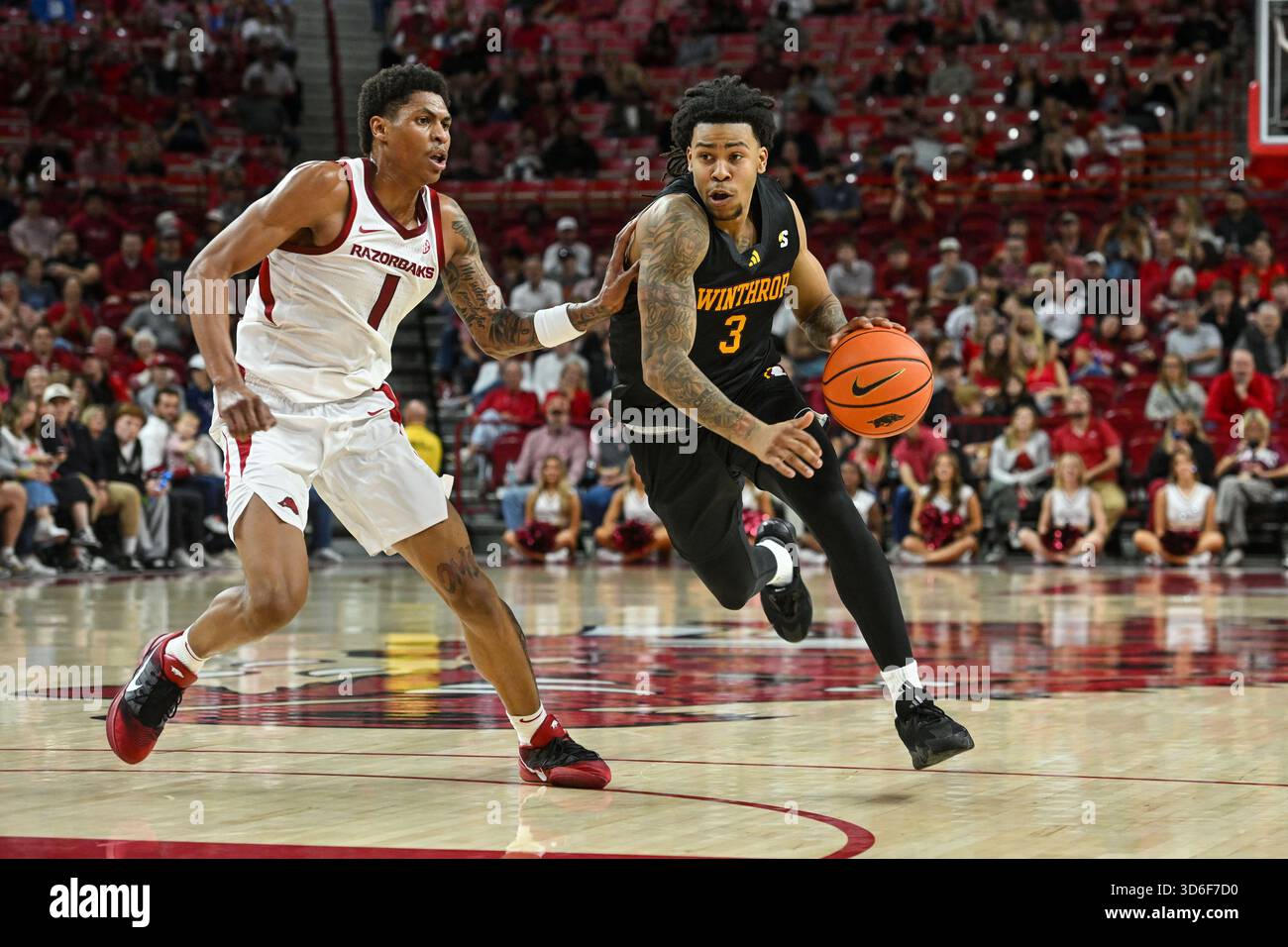 Winthrop guard Josh Meo (3) tries to drive past Arkansas guard Meleek ...