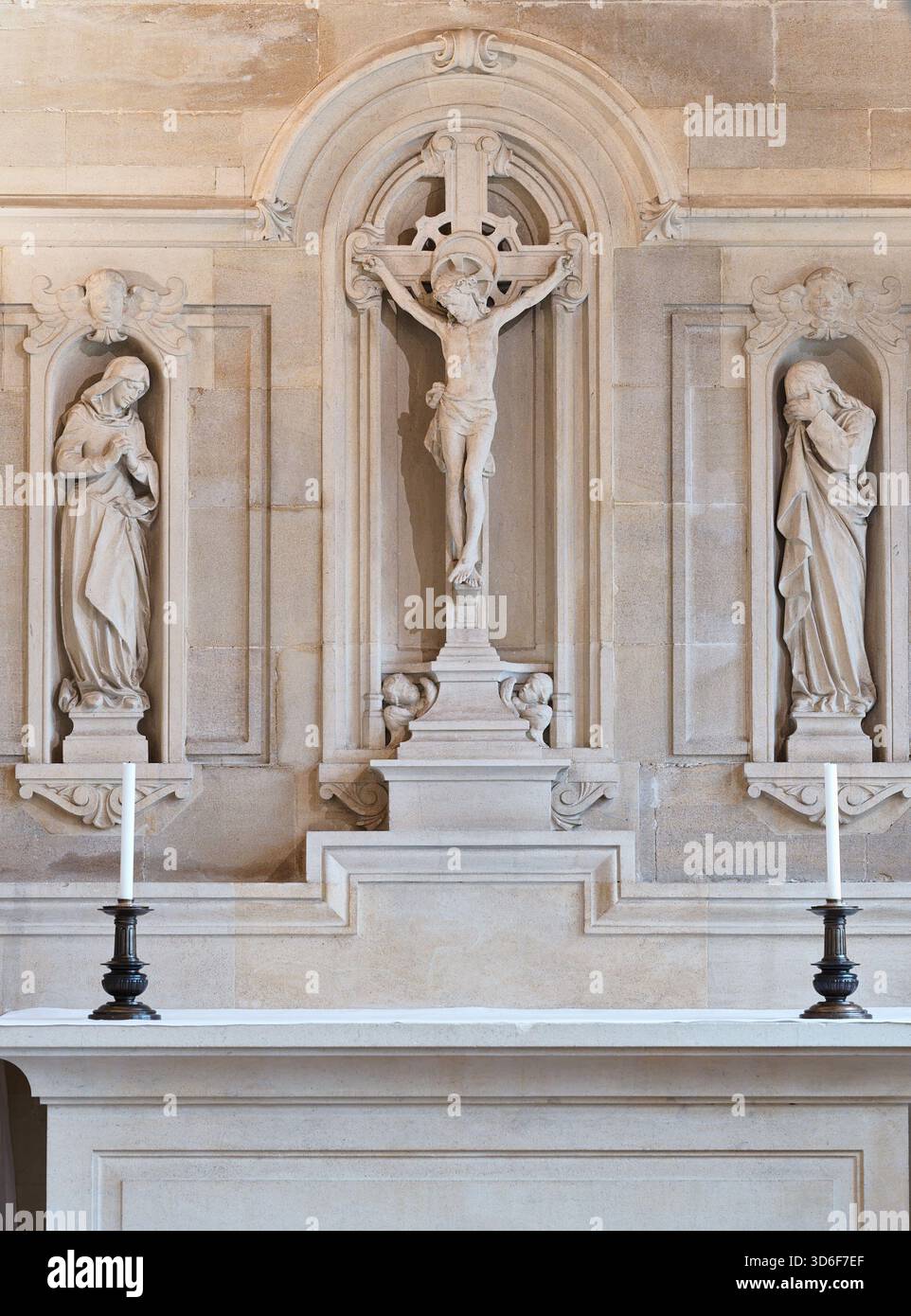 A stone crucifix, of the crucified Jesus Christ flanked by two ...