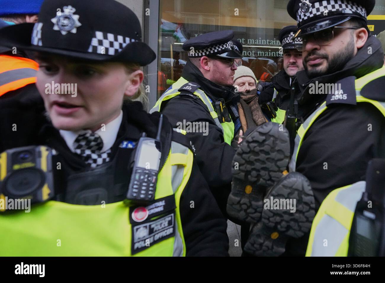 Police lift and arrest a protester outside the Ministry of Justice ...