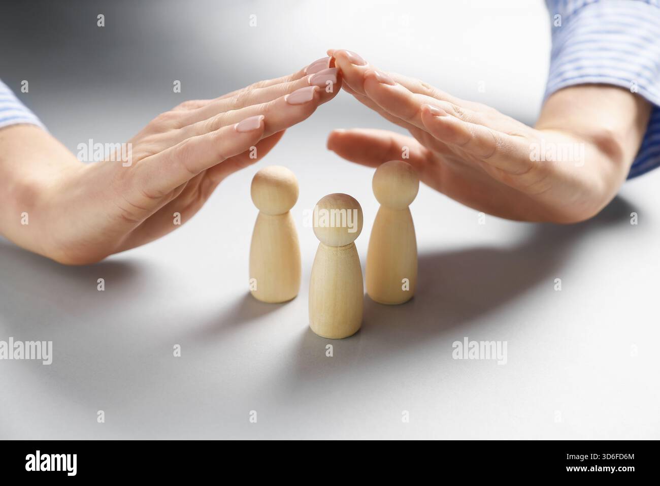 Woman protecting human figures hi-res stock photography and images - Alamy