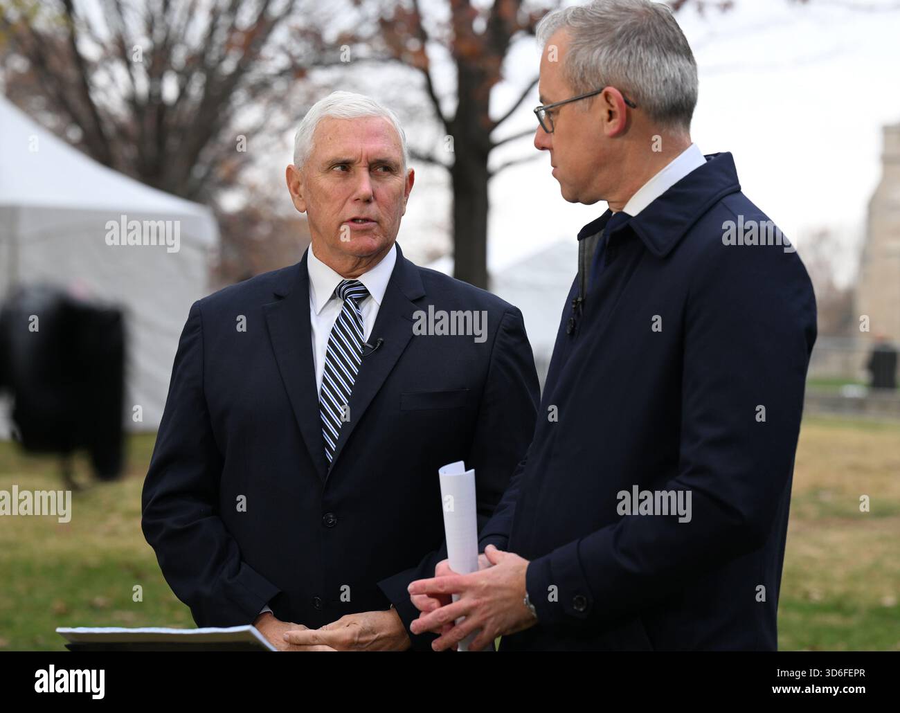 Former Vice President Mike Pence (L) speaks to a reporter before the ...