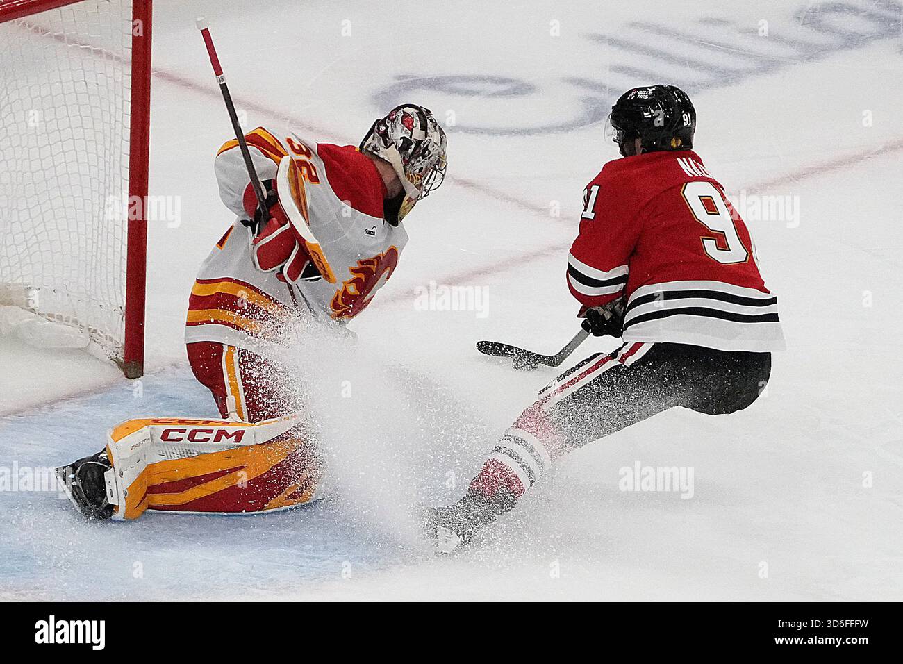 Calgary Flames goaltender Dustin Wolf (32) makes a save on Chicago ...