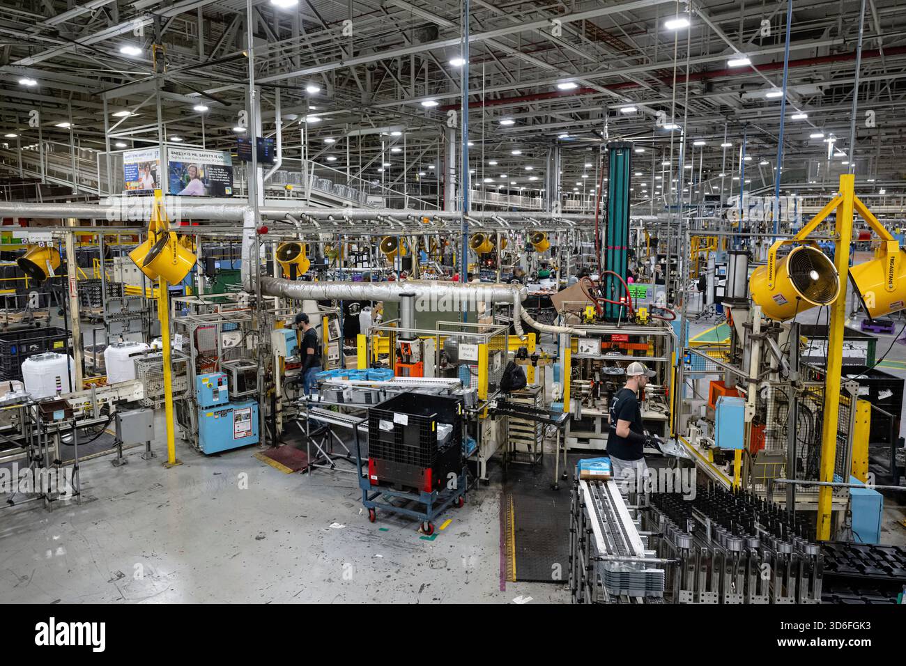 FILE - Employees piece together components on an assembly line at GE ...