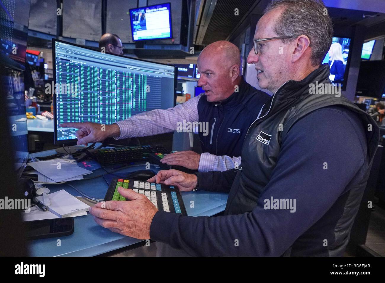 Specialists John O'Hara, left, and Glenn Carell work on the floor of ...