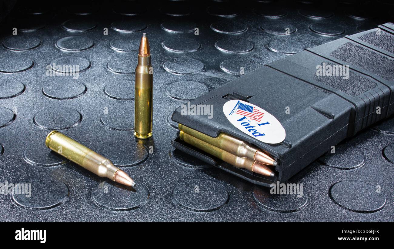 I voted sticker on an AR-15 magazine loaded with cartridges and an I ...