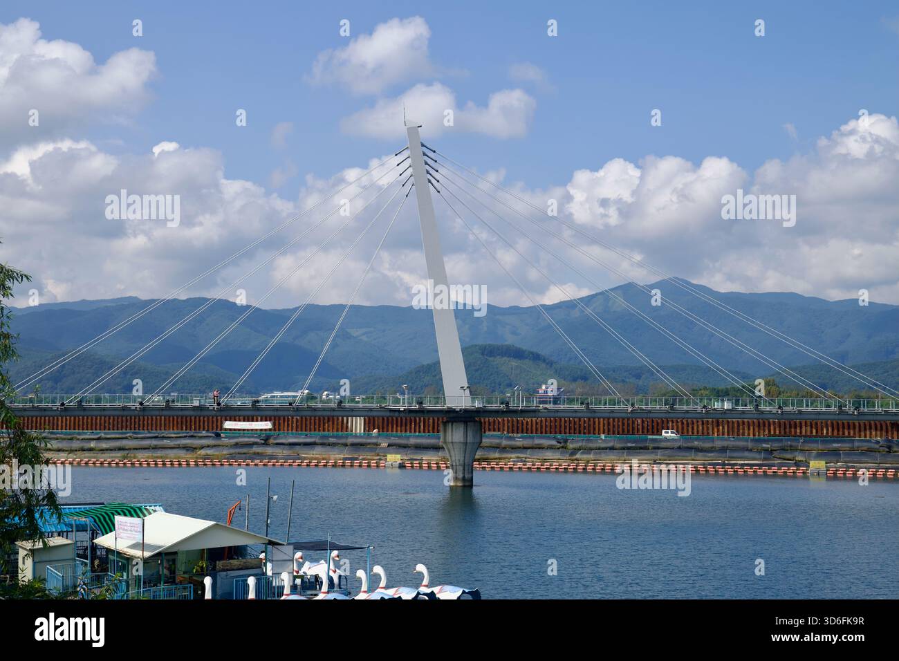 The cable-stayed pylon of Chuncheon’s bridge rises from the lake with ...