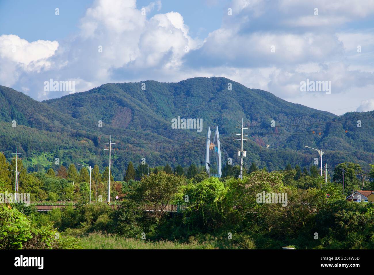 Forest-covered hills rise behind the slim twin spires of the Jarasum ...