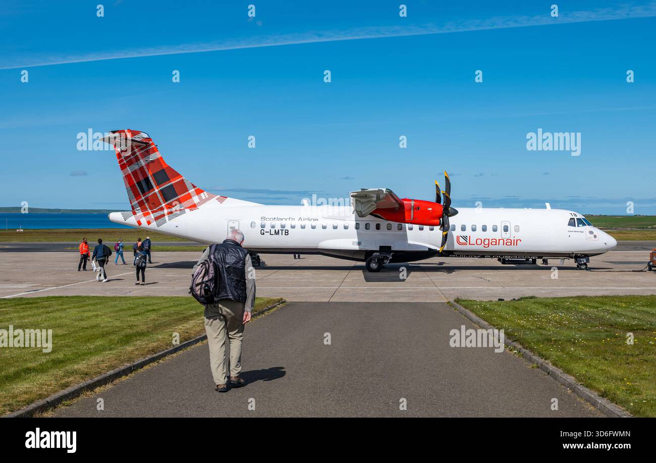 Passengers boarding Loganair aeroplane, Kirkwall Airport, Orkney ...