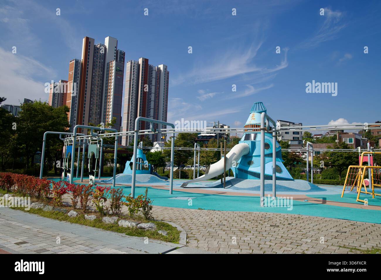 A rocket-shaped playground tower with slides and climbing frames ...