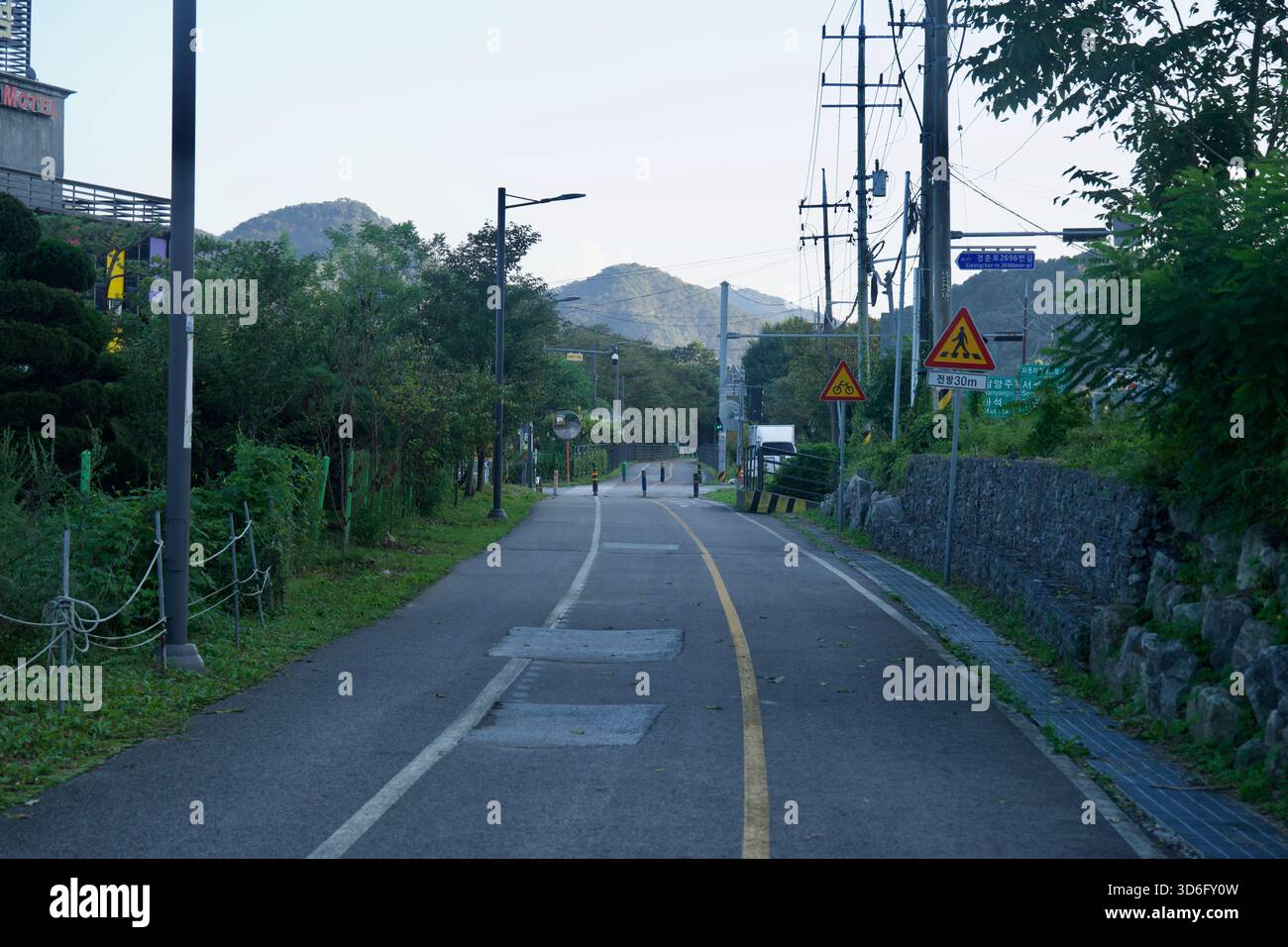 Bicycle and pedestrian warning signs line a shared corridor of the ...