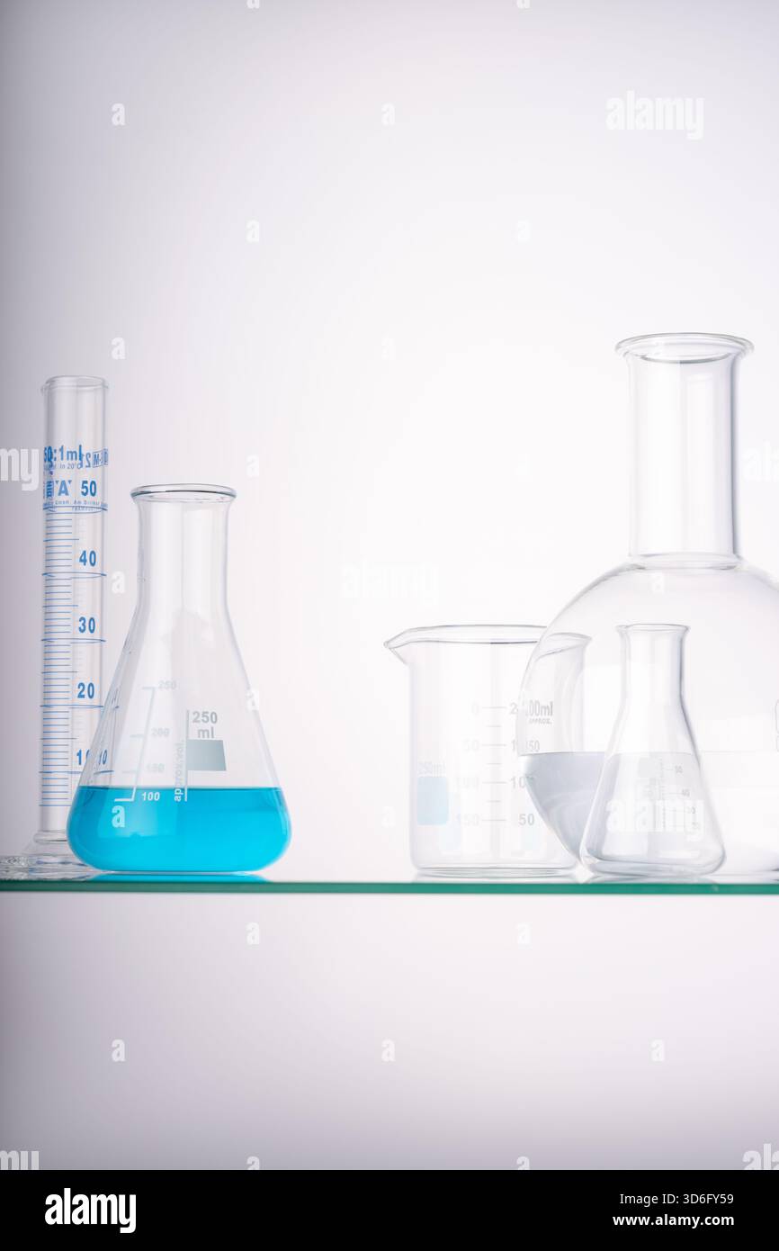 Laboratory equipment beakers and flasks with backlight in different ...