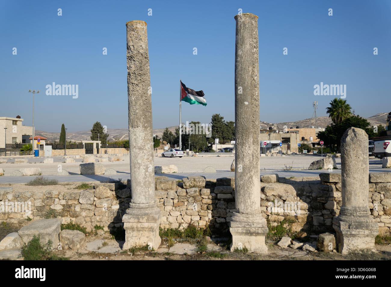 A Palestinian flag flies over the Roman historical site in the West ...