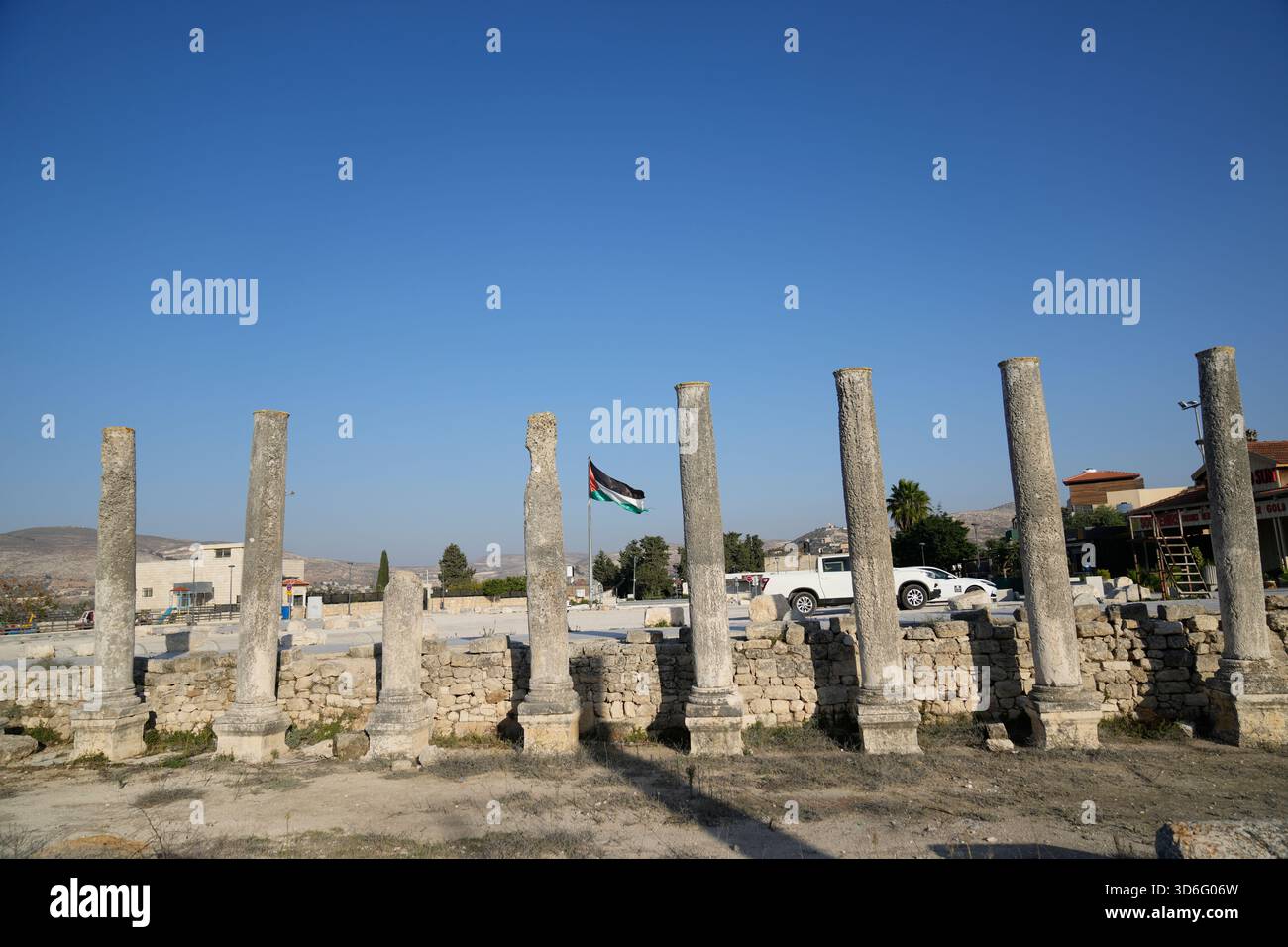 A Palestinian flag flies over the Roman historical site in the West ...