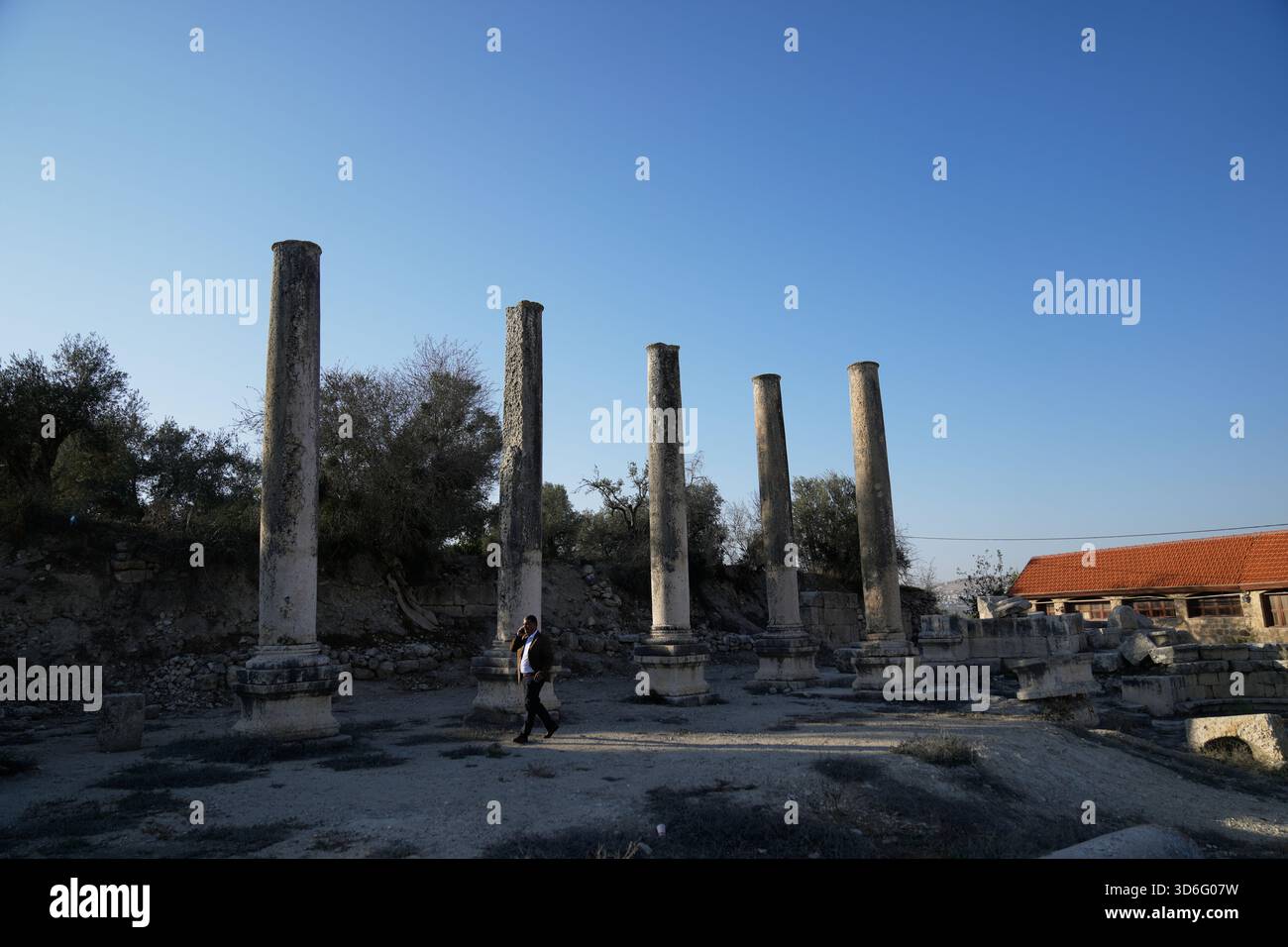 Palestinian Muhammad Azem, the mayor of Sebastia, inspects the Roman historical site in the West ...