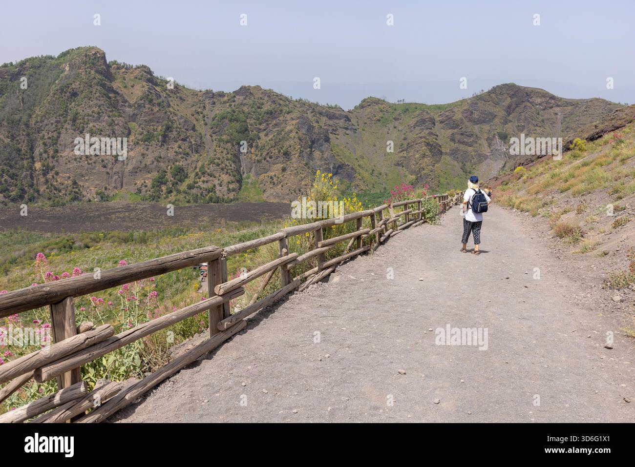 Tourists walking along the footpath to the top of Vesuvius volcano on a ...