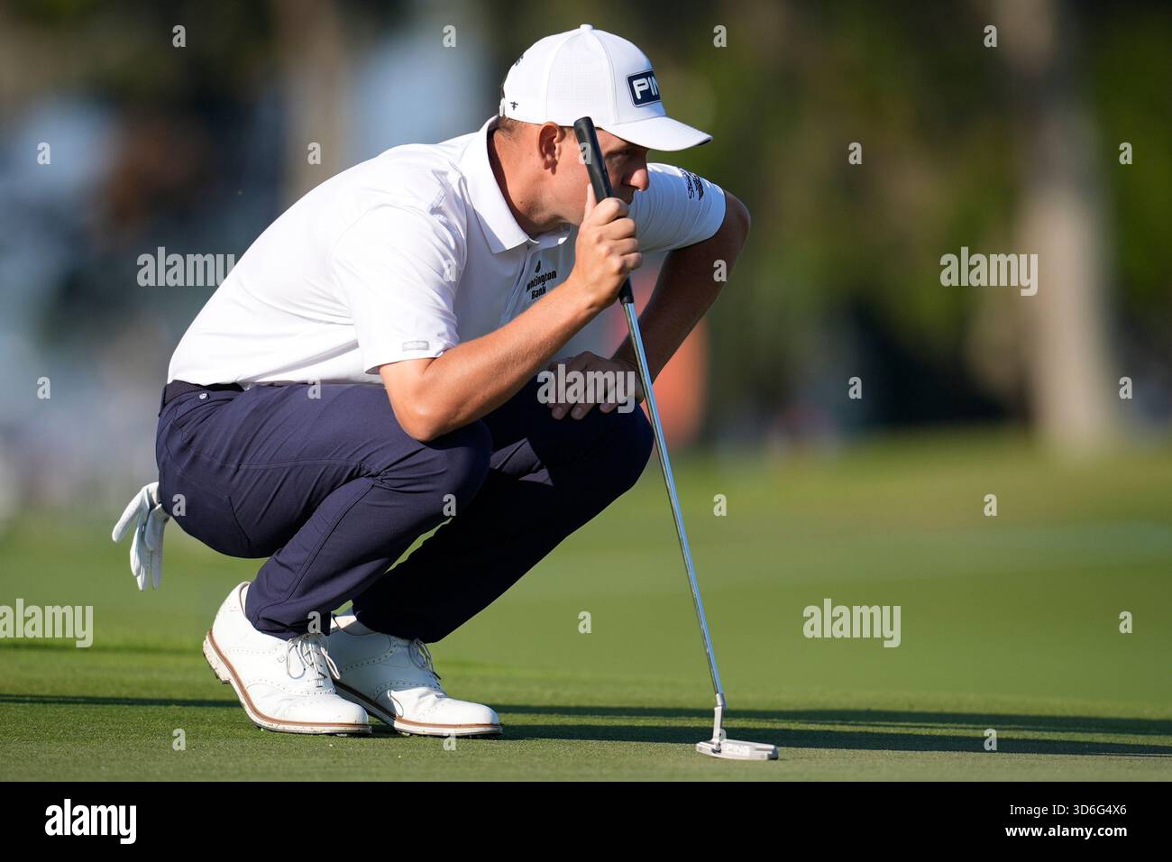 Sam Stevens lines up a putt on the first fairway during the first round ...