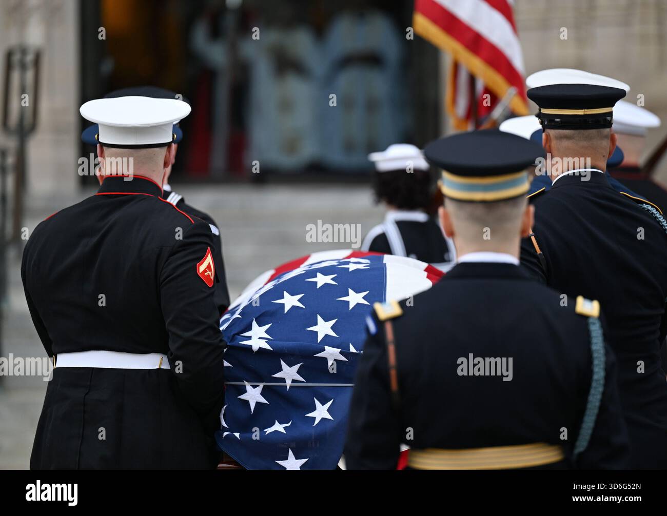 A military guard carries the casket of former Vice President Dick ...