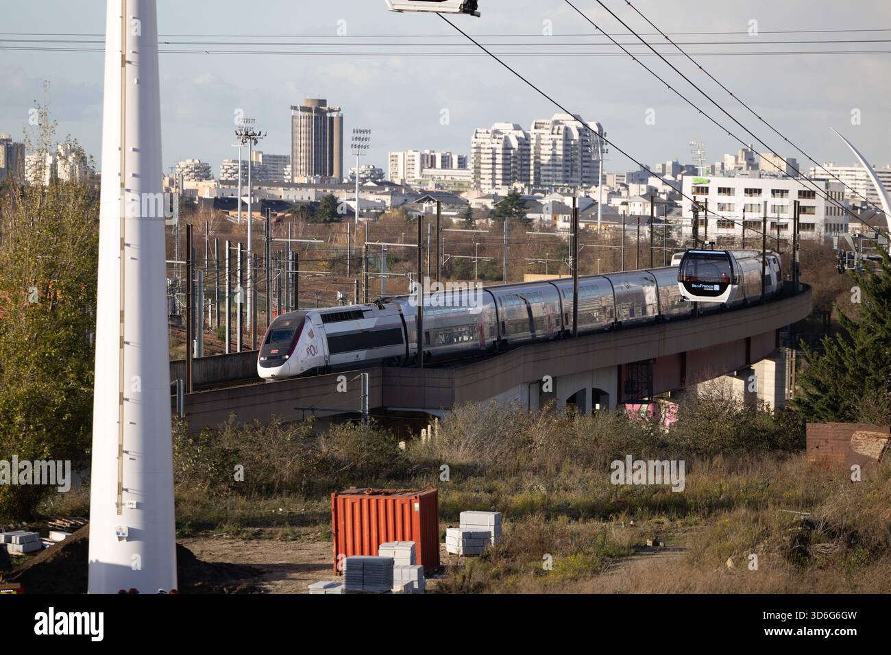A train runs next to cabins from the first urban cable car in the Paris ...