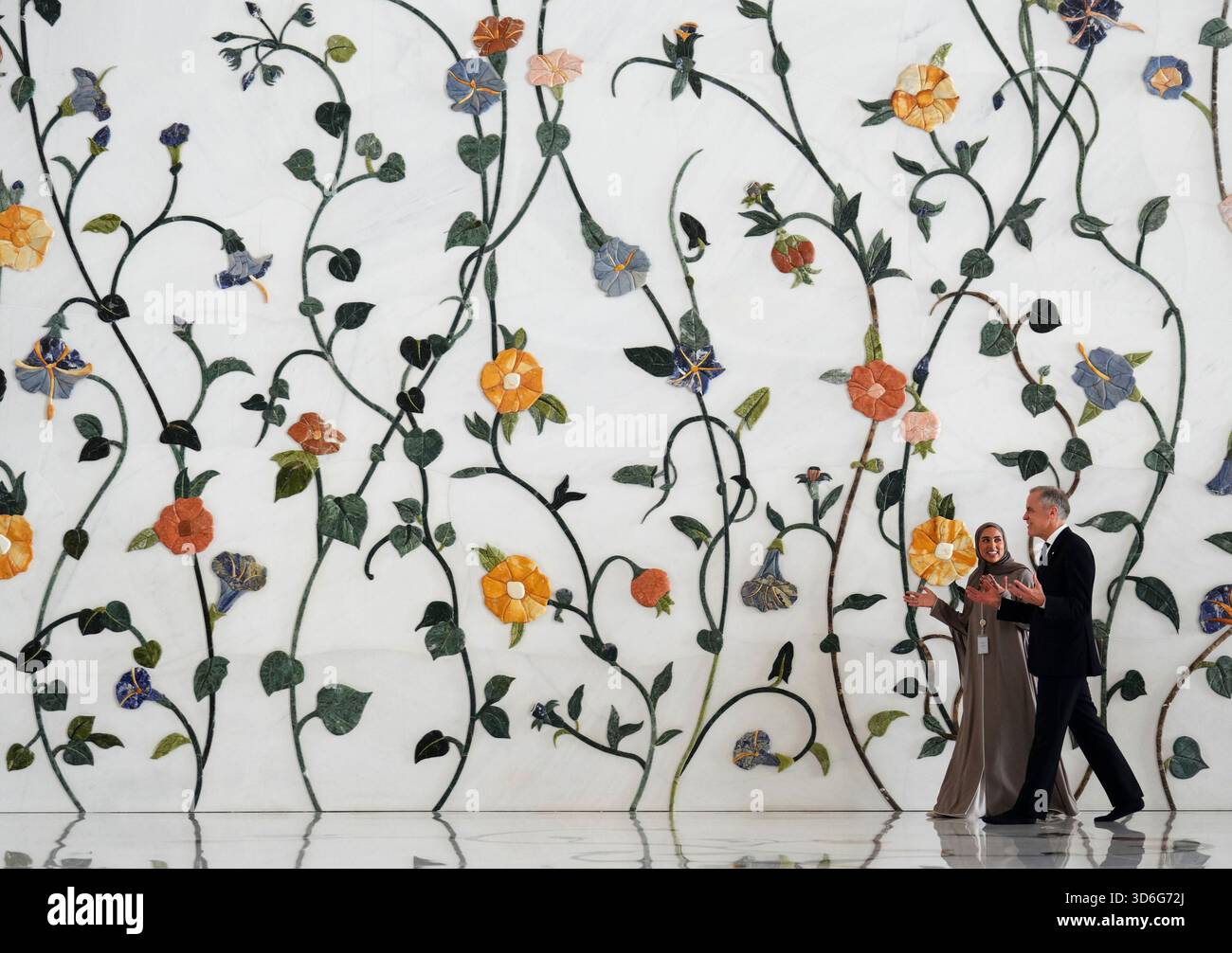 Canada's Prime Minister Mark Carney, right, walks with Aisha Mubarak ...