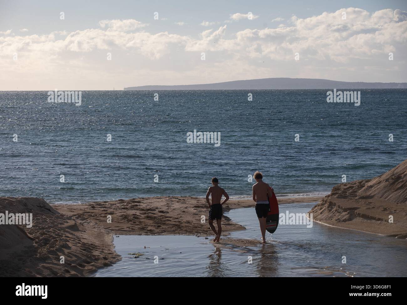 20 November 2025, Spain, Palma: People relax and sunbathe on the beach ...