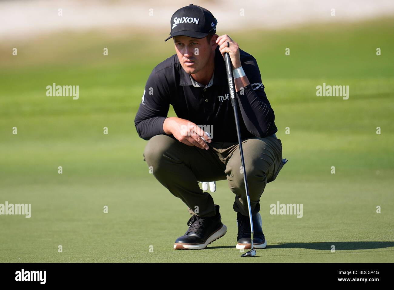 Andrew Putnam lines up his putt on the 18th green during the first ...