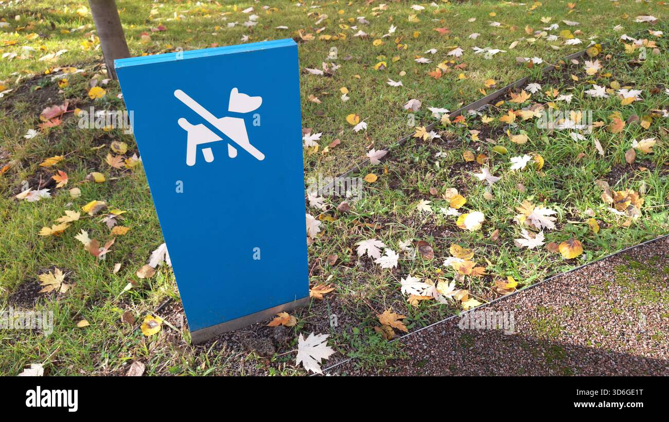 Blue outdoor sign with a crossed-out dog symbol indicating no pets ...
