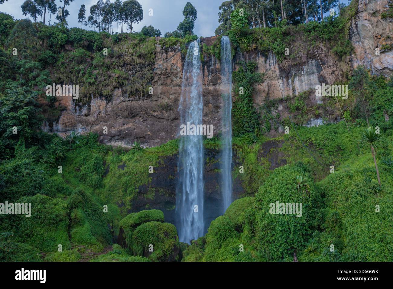 Aerial view of a majestic waterfall cascading down a verdant cliff face ...