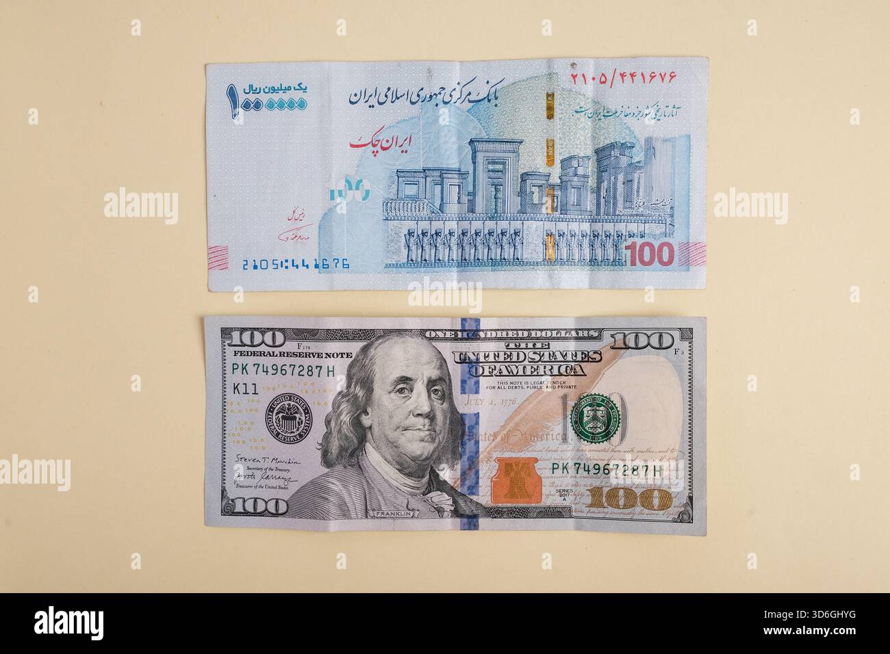 A comparison of two banknotes: an Iranian 100 rial note featuring ...