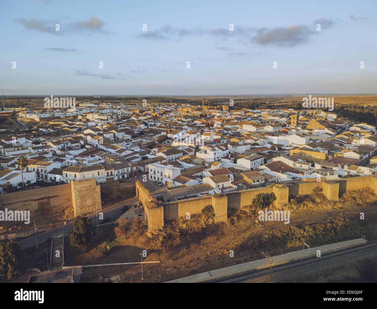 Aerial view of golden sunlight bathes the ancient walls and white ...