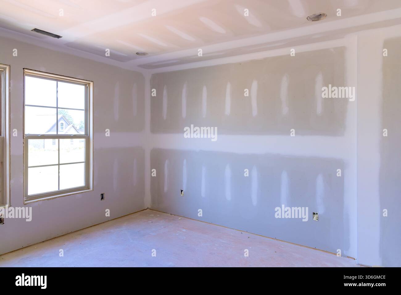 Empty room with freshly installed drywall unpainted surfaces ready for ...
