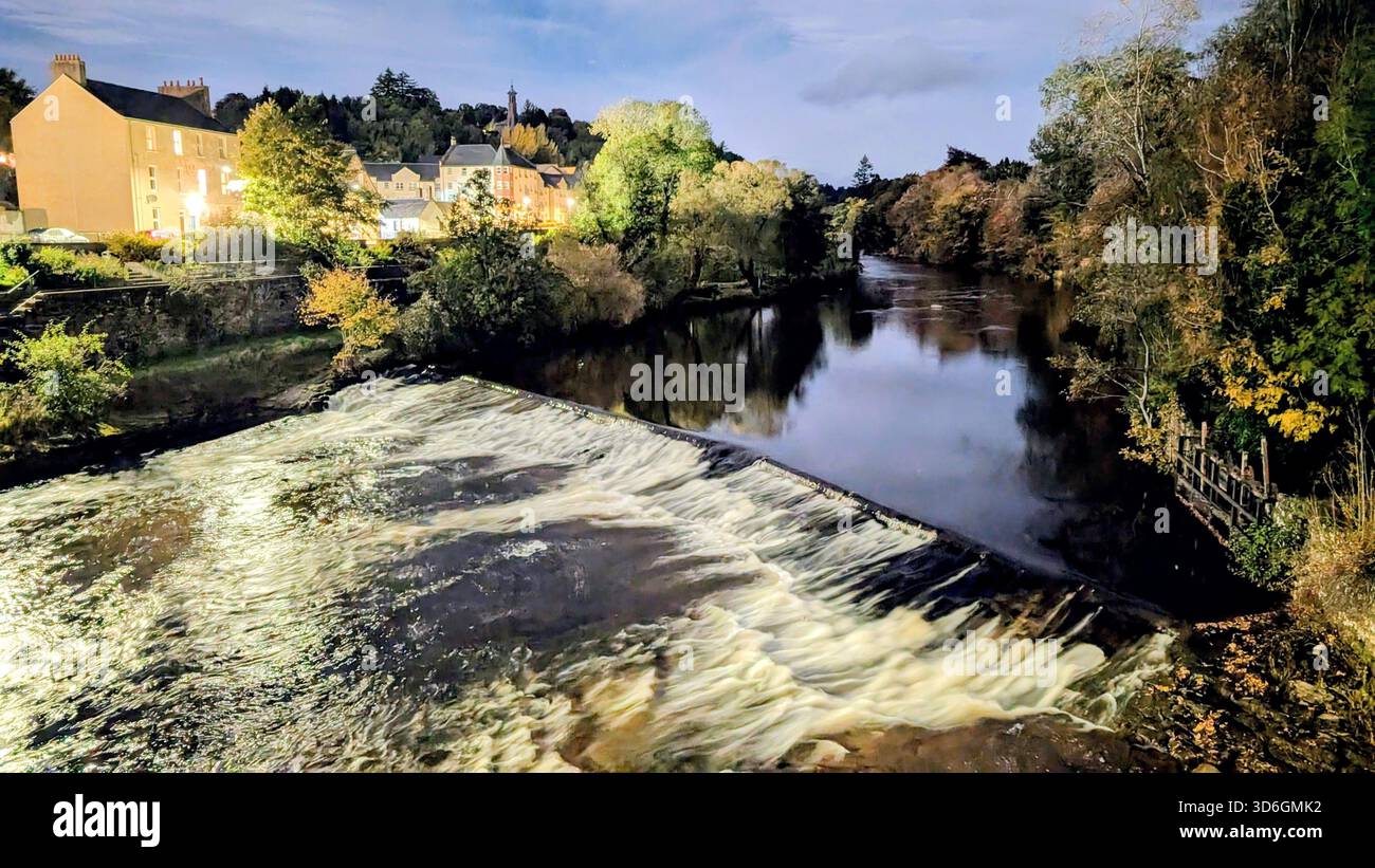 Night view of the River Ericht and the small wide waterfall seen from ...