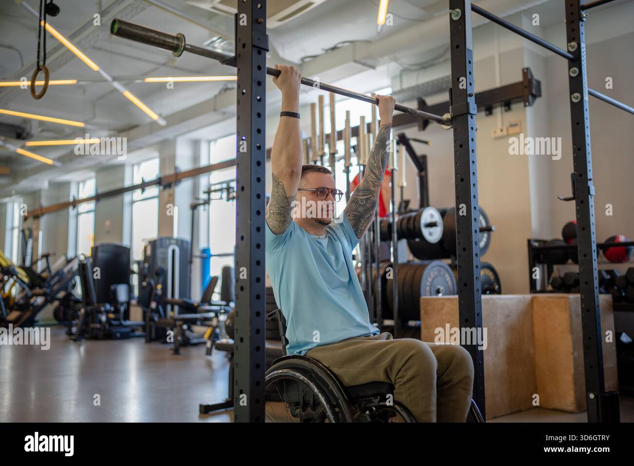 Man in wheelchair do adaptive vertical pull ups using fitness equipment ...