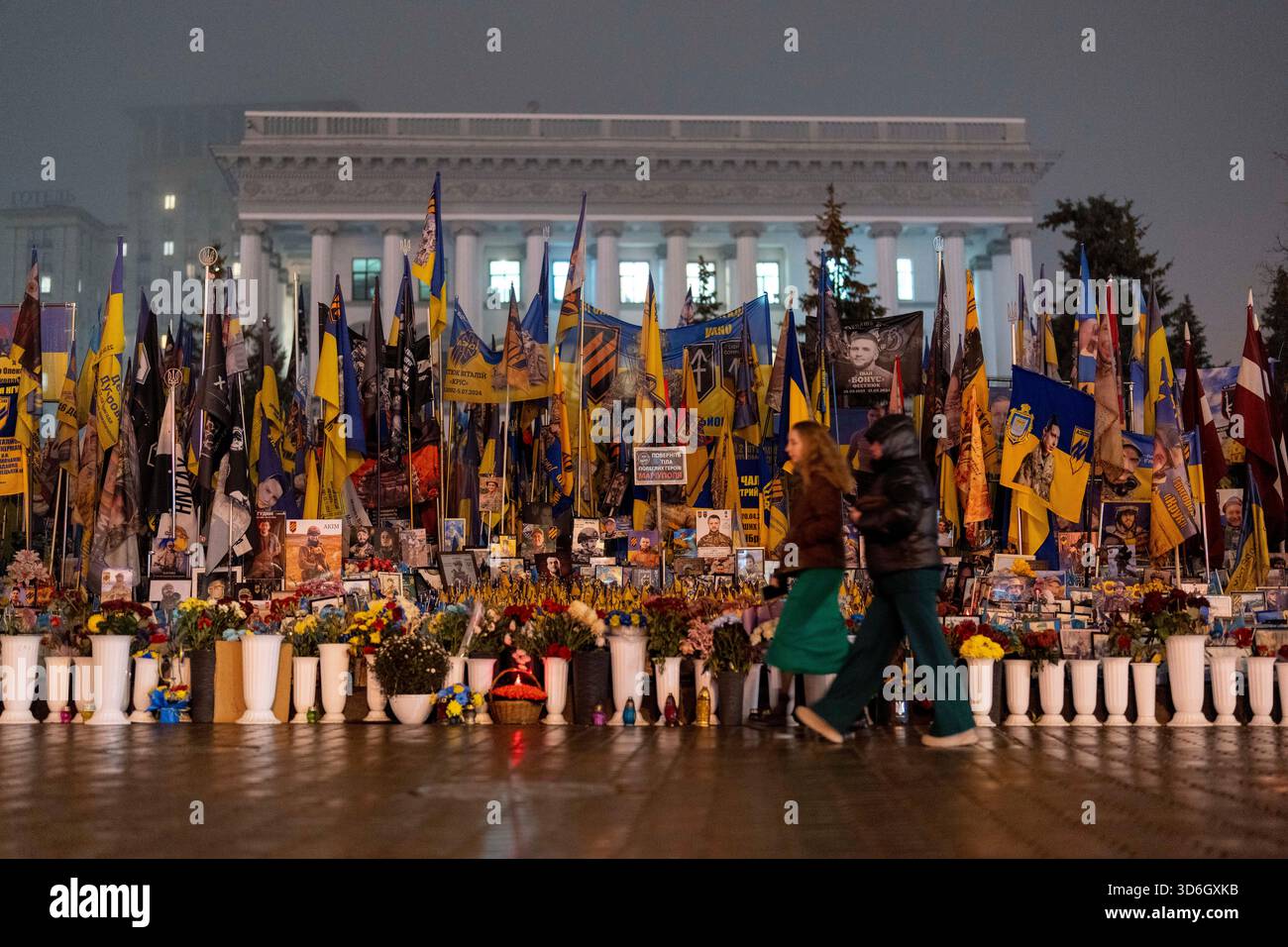 People walk by flags at Independence Square Maidan Nezalezhnosti that ...