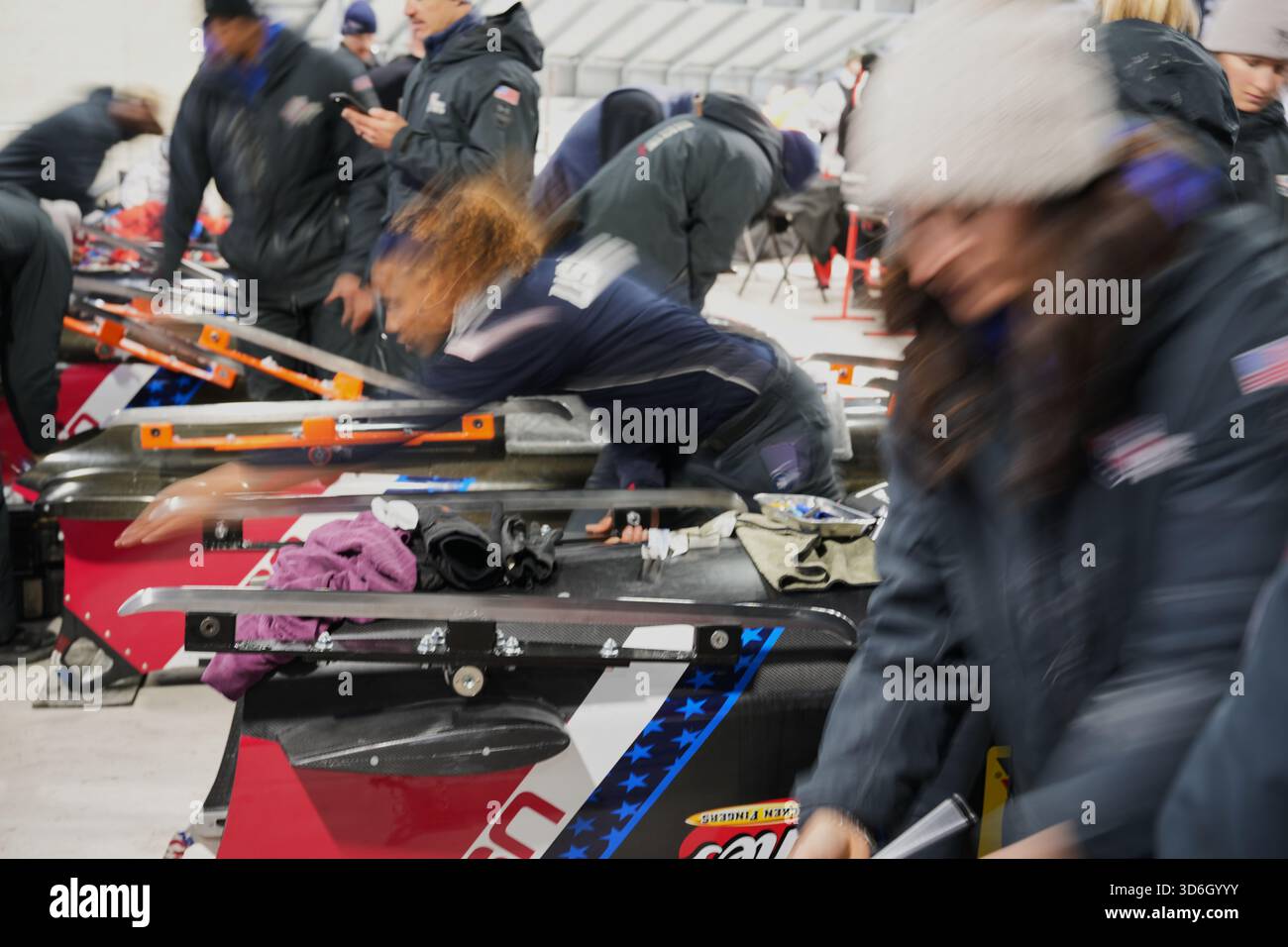 Members of the United States team work on bobsleds during a training ...