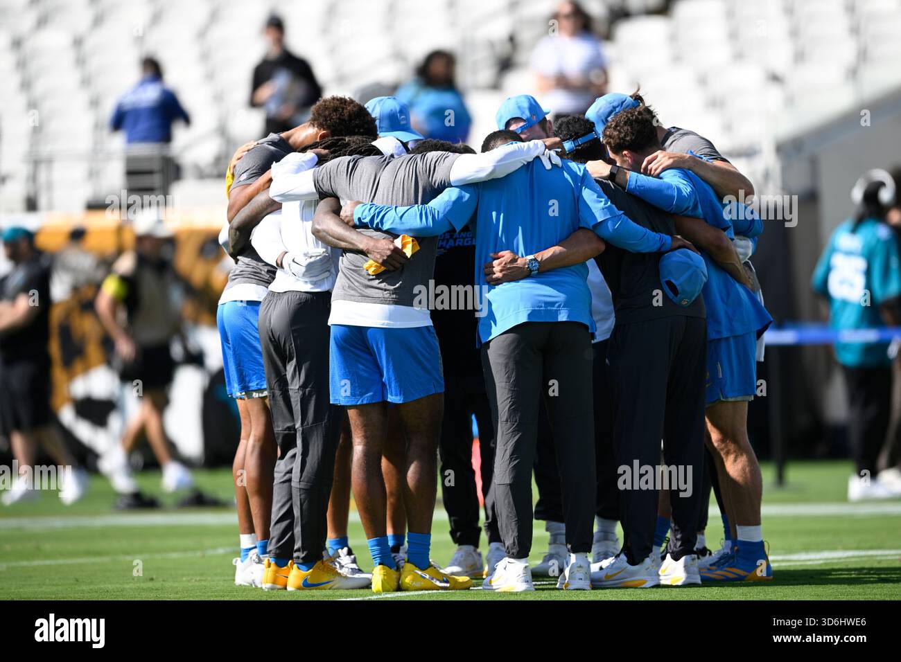 Los Angeles Chargers players huddle on the field while warming up ...