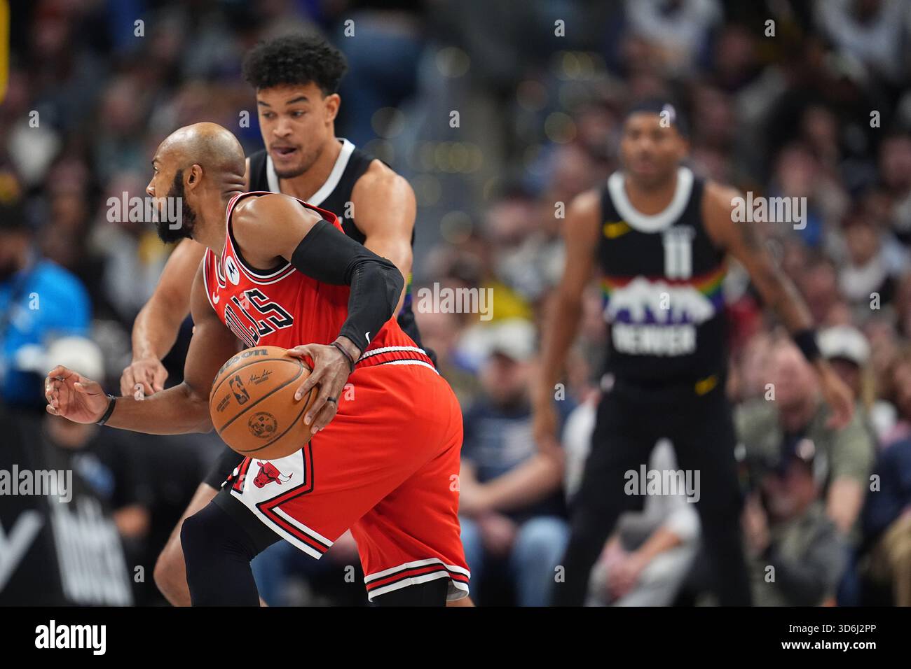 Chicago Bulls guard Jevon Carter (5) drives past Denver Nuggets forward ...